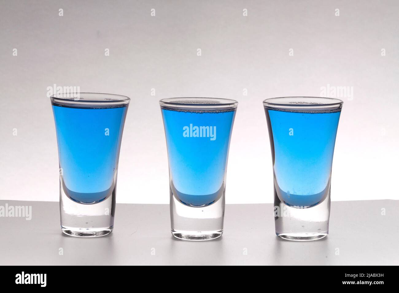 Three alcoholic multicolored alcoholic shots for advertising layout ...