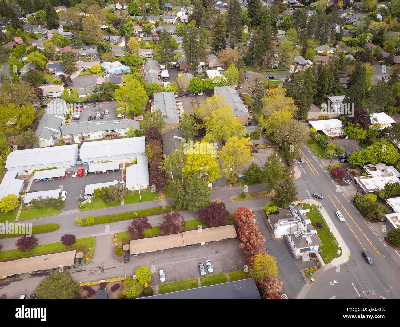Shooting from a drone. Town, suburb. Lots of greenery, paved roads ...