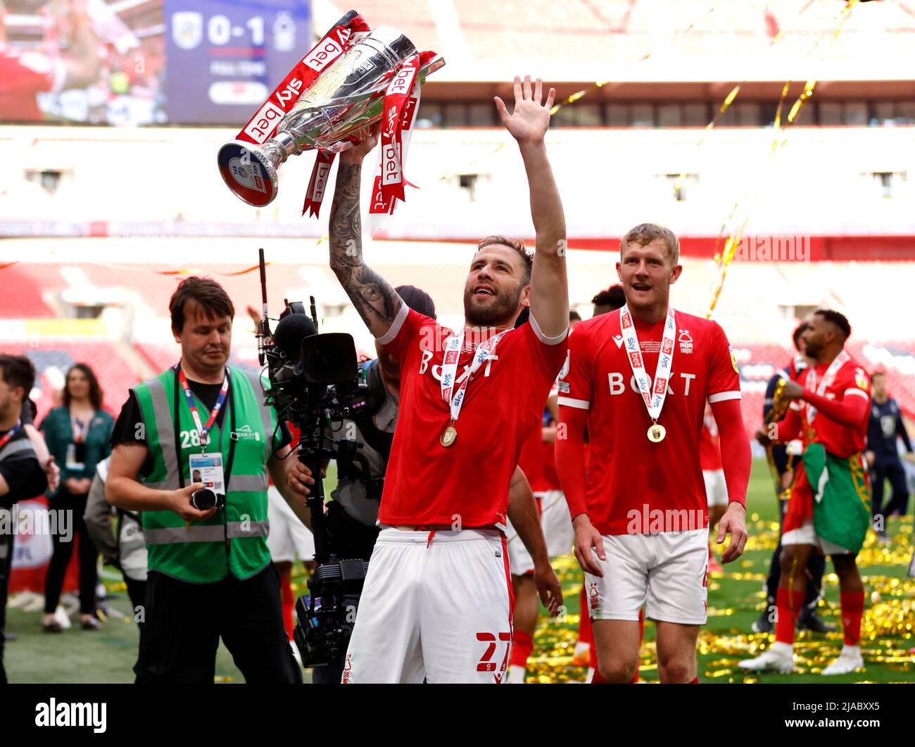 Nottingham Forest's Steve Cook lifts the trophy following promotion to ...