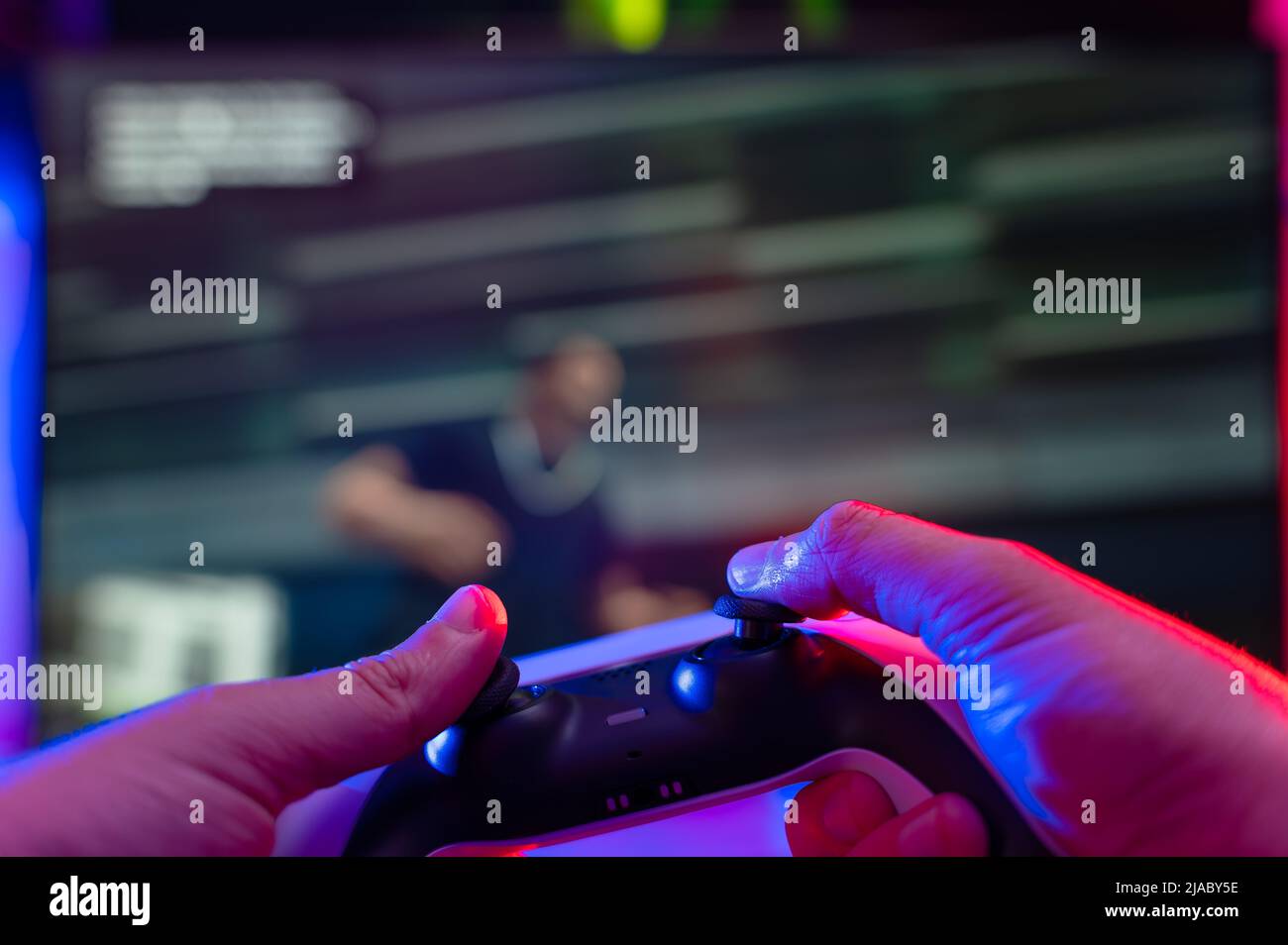 Modern joystick in the hands of a gamer. A gamer plays video games ...