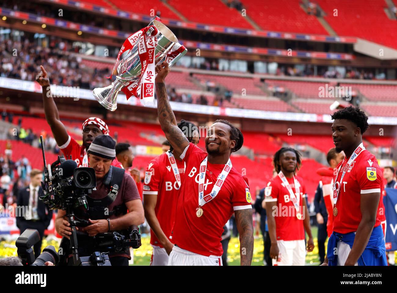 Nottingham Forest's Gaetan Bong lifts the trophy following promotion to ...