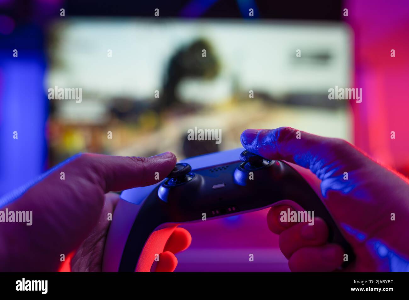 Close-up. Gamepad in the hands of a gamer on a technological background ...