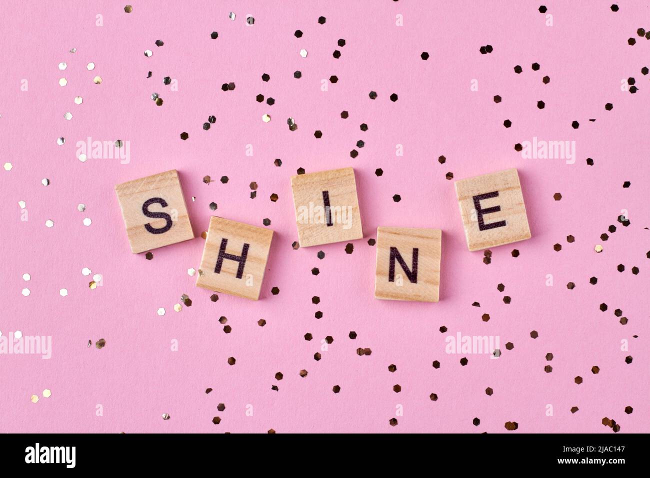 Word shine written on wooden blocks on pink background. Flat lay ...