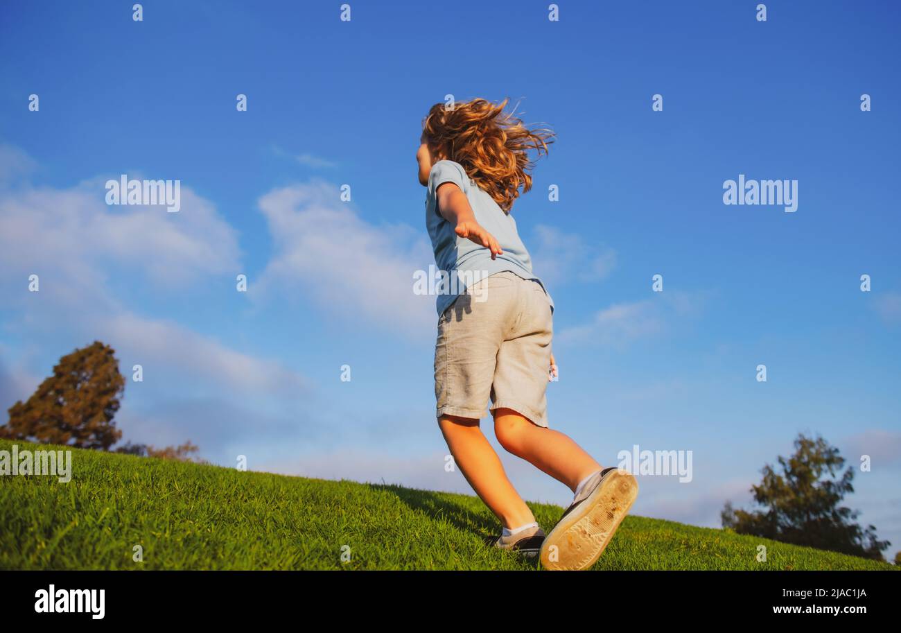 Child boy running on meadow. Happy kid run on beautiful summer field ...