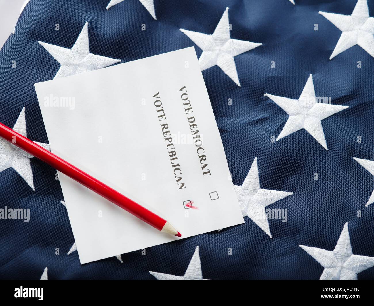 Voting ballot, red pencil on the background of the American flag ...