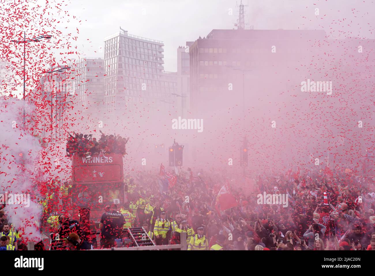 Confetti explodes as Liverpool players ride on an open-top bus during ...
