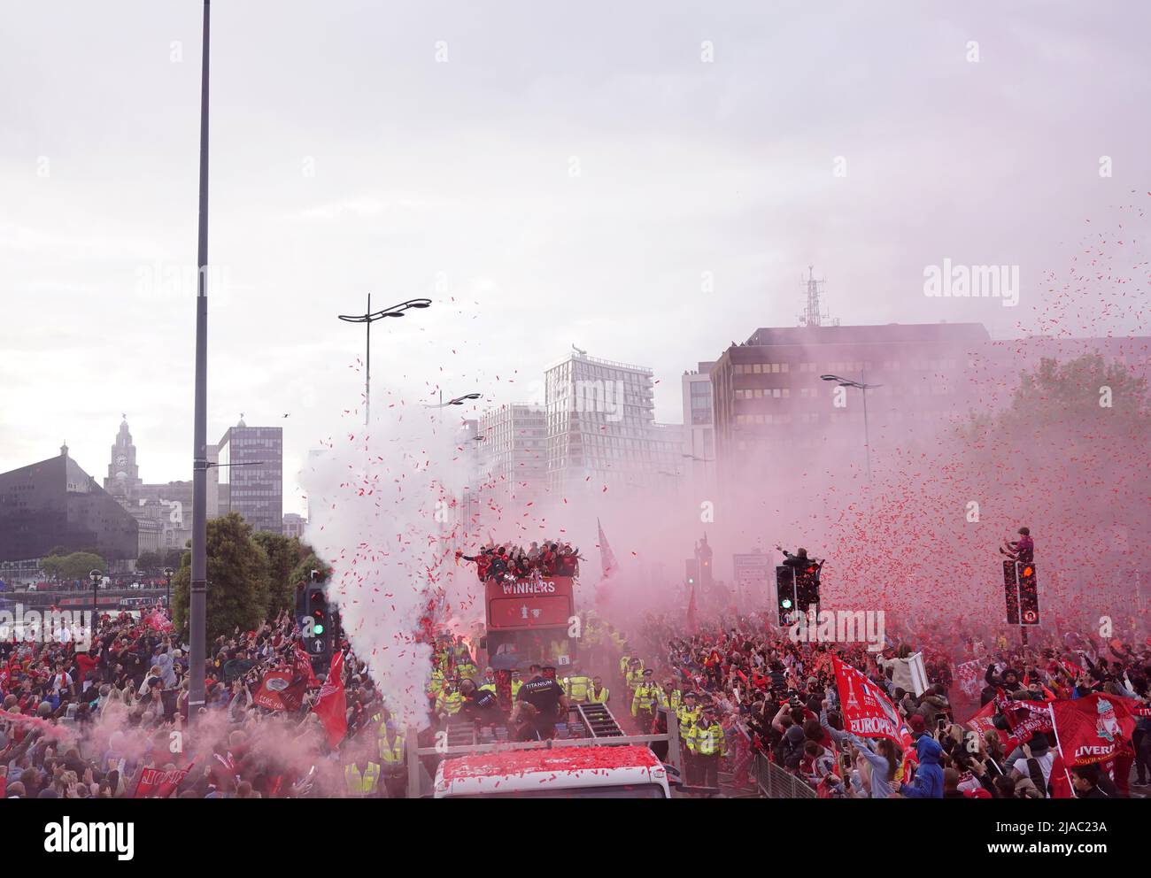 Confetti explodes as Liverpool players ride on an open-top bus during ...