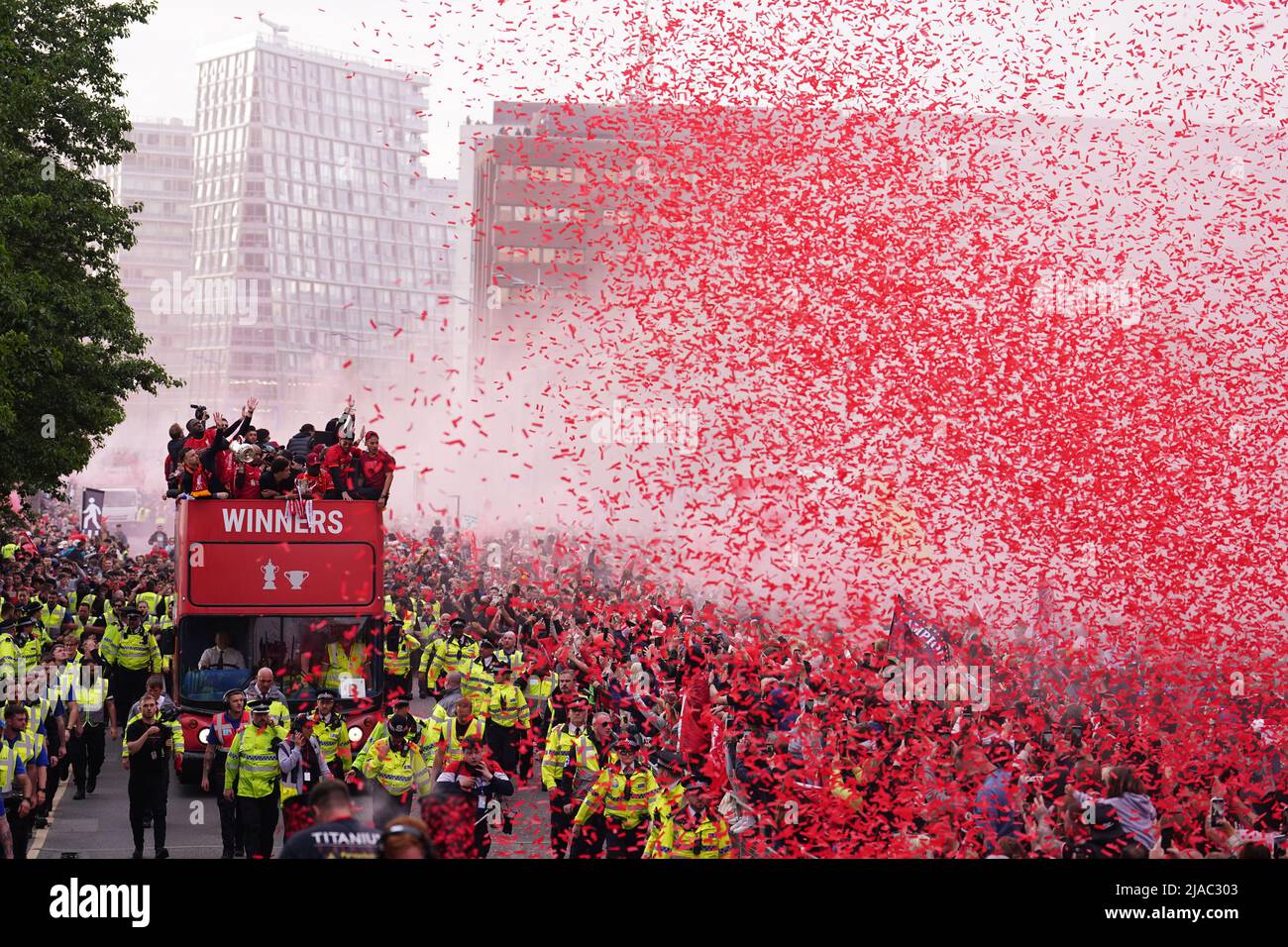 Liverpool players ride on an open-top bus during the trophy parade in ...