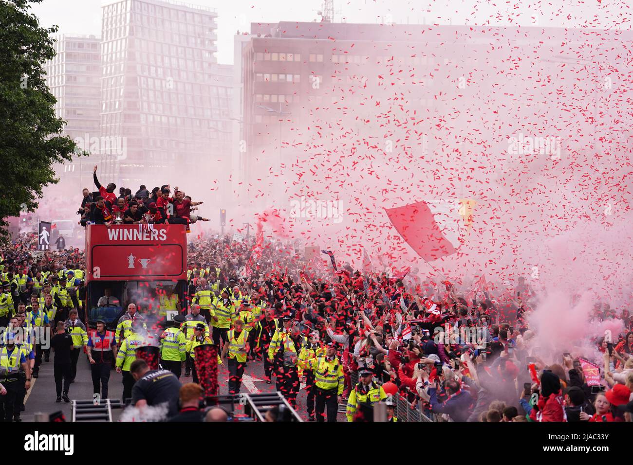 Liverpool players ride on an open-top bus during the trophy parade in ...
