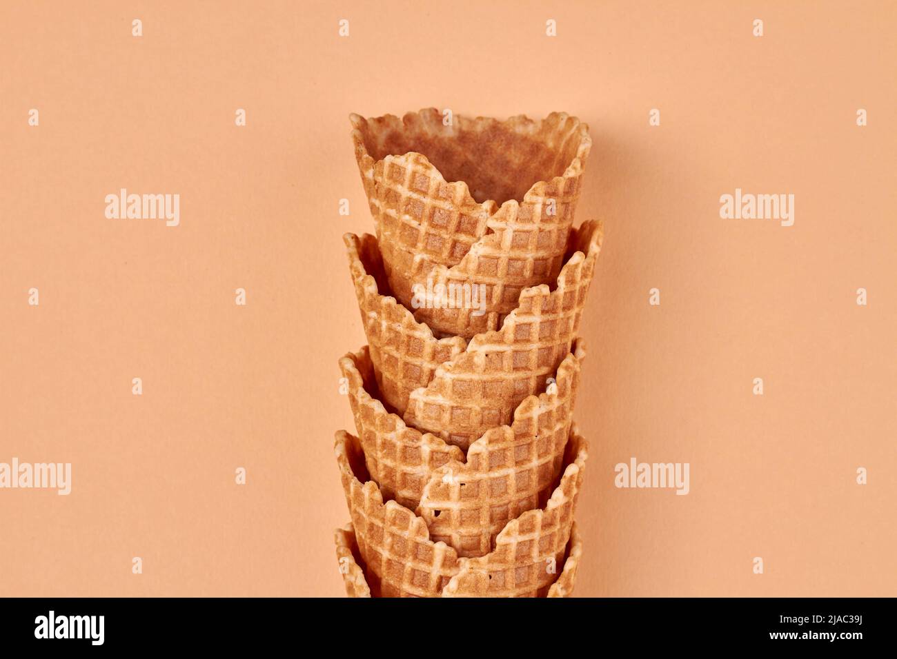 Delicious sweet ice-cream cones set on color background. Space for text ...