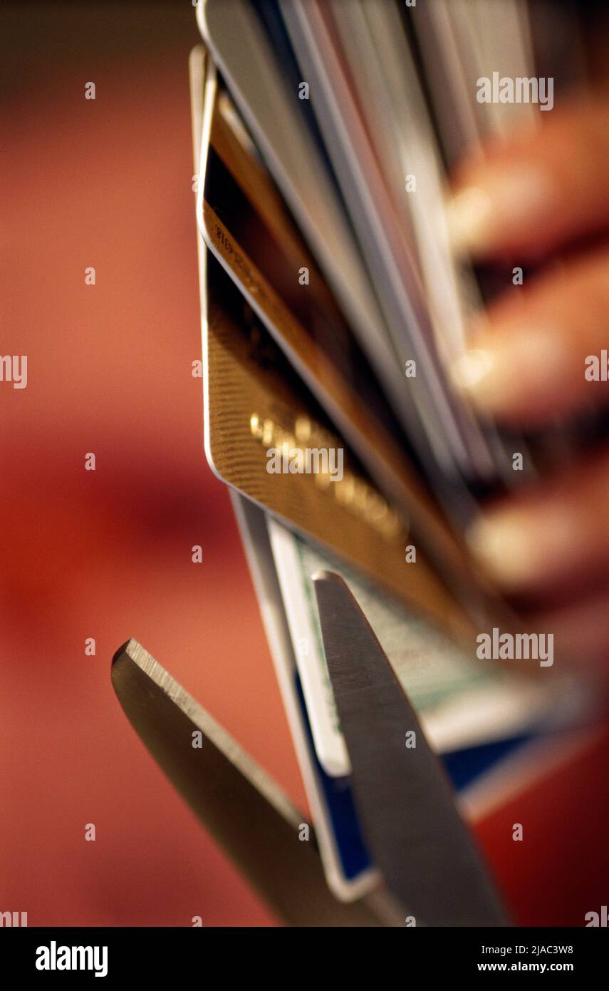 Close-up of woman cutting up credit cards with scissors Stock Photo - Alamy