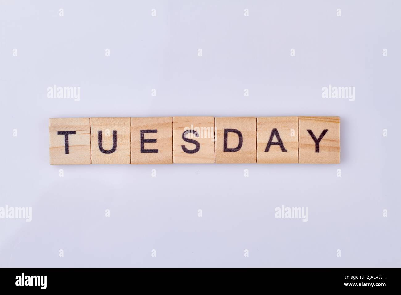 Tuesday word written with vintage wooden cubes and black letters ...