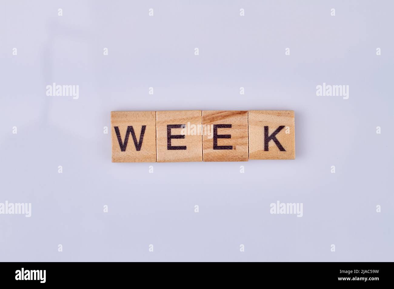Week word made with wooden cubes and black letters. Isolated on white ...