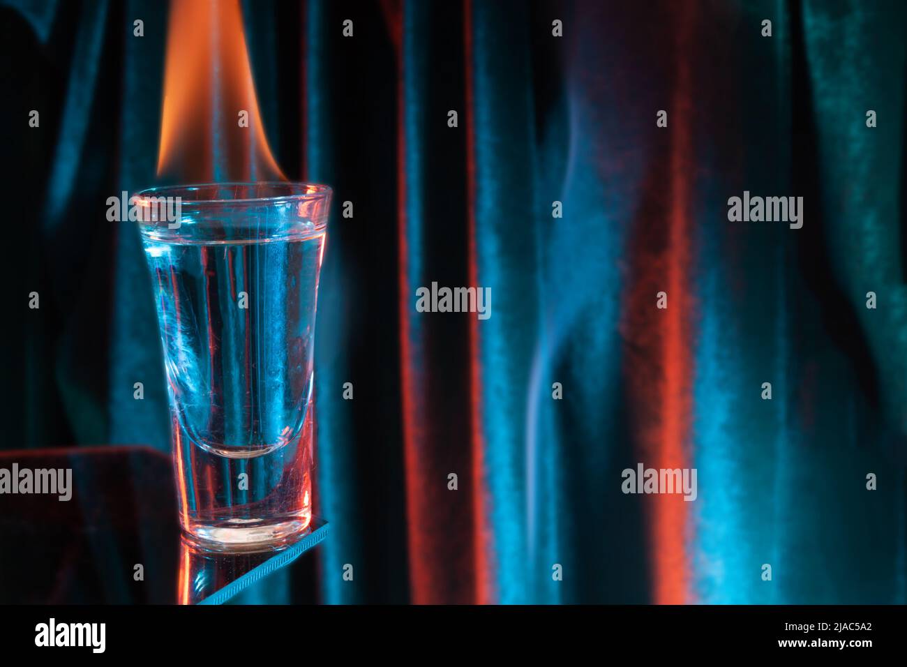 Glass of Mexican tequila, vodka with burning liquid. Glass of vodka on ...
