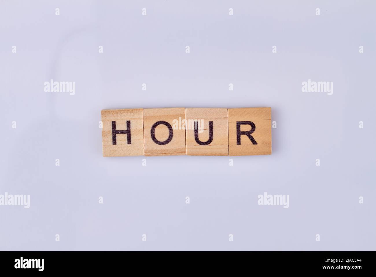 Hour word written on wooden blocks. Isolated on white background. Flat ...