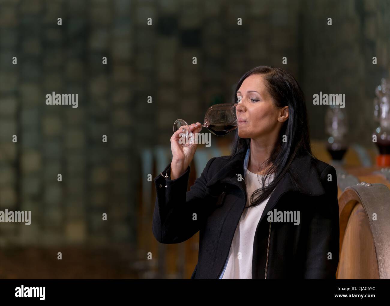 Woman tasting red wine in a old traditional cellar Stock Photo - Alamy