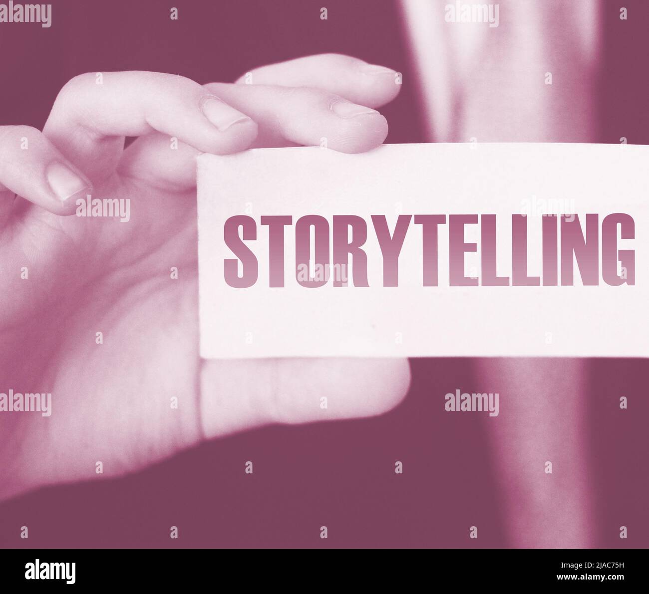 Businessman holding a card with word Storytelling. Copywriting telling ...