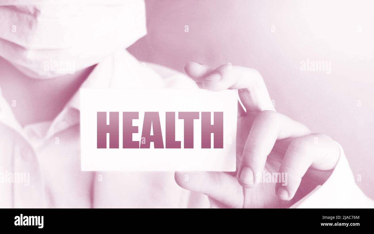 Health word card in hands of Medical Doctor Stock Photo - Alamy