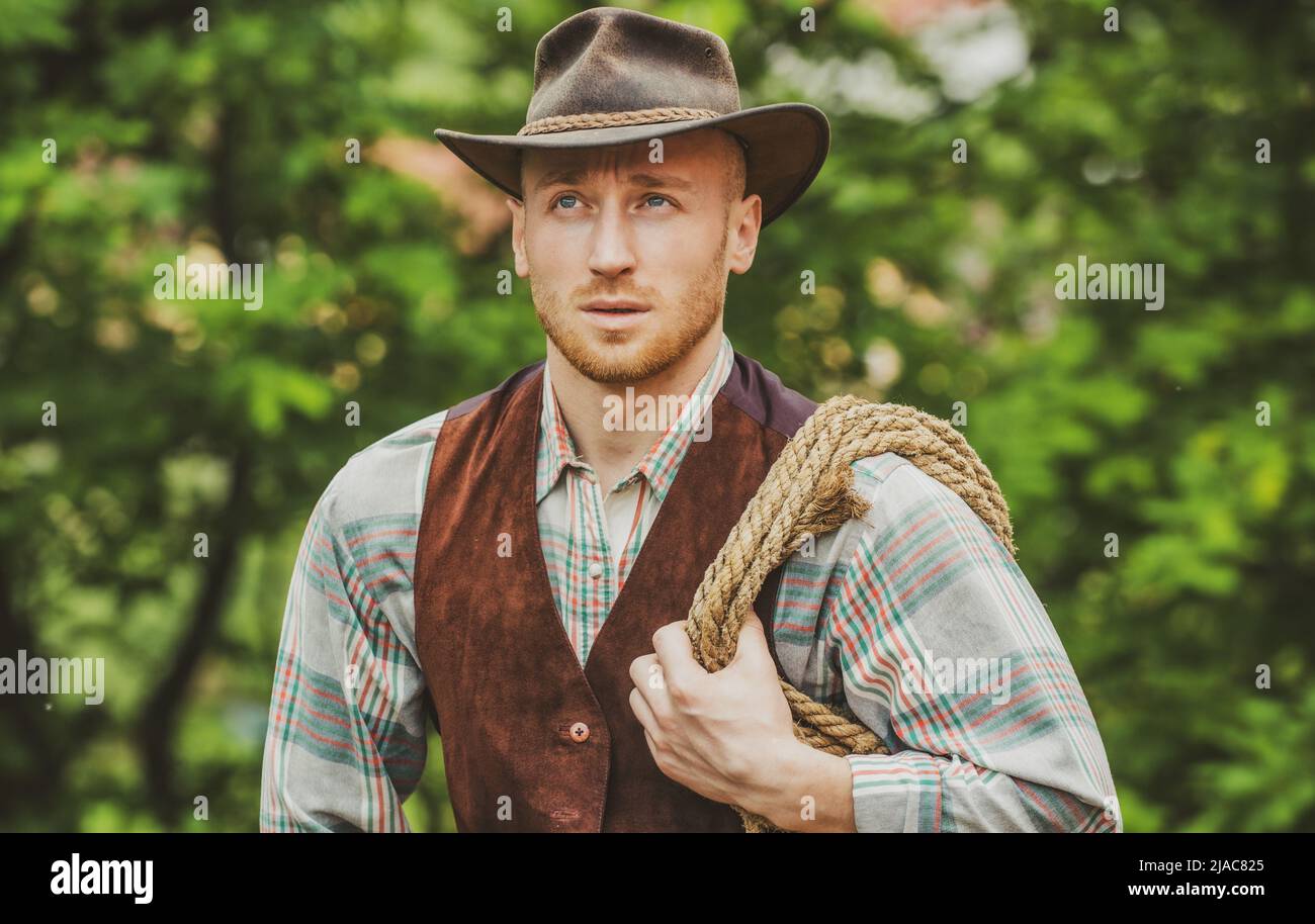 Cowboy with lasso rope on green background. Western life. Handsome ...