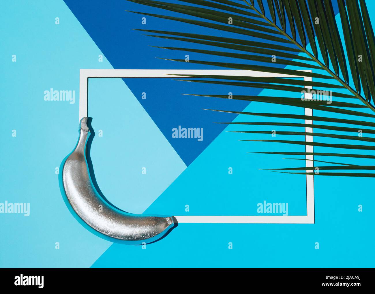 Silver painted banana on three different blue backgrounds. Summer fruit ...