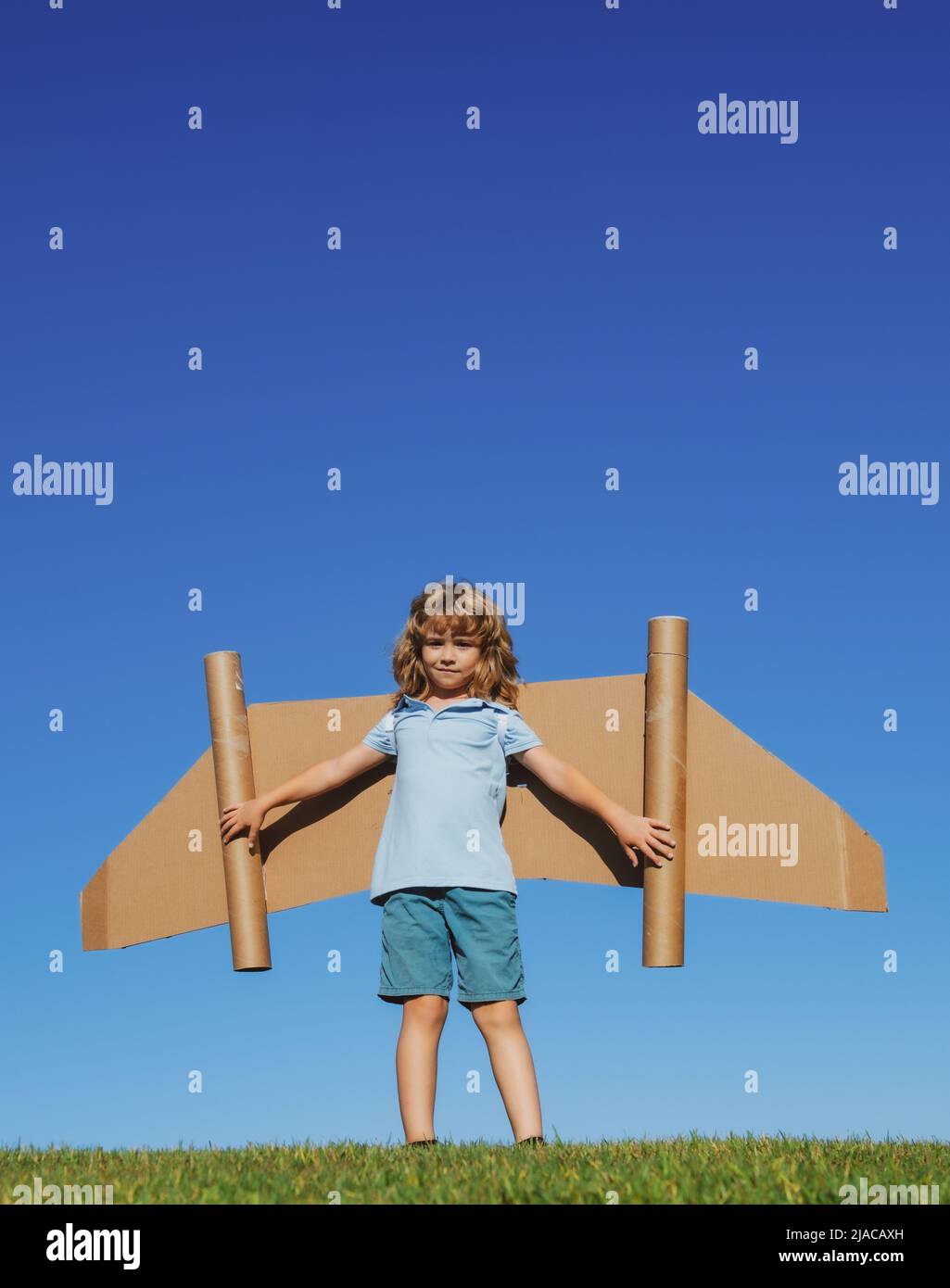 Dreams of travel. Child flying on jetpack with toy airplane on sky ...