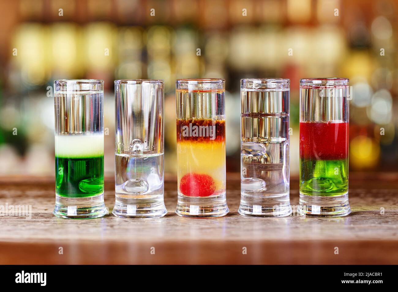 Assortment of cocktails on the bar in a nightclub. Cheerful alcohol ...