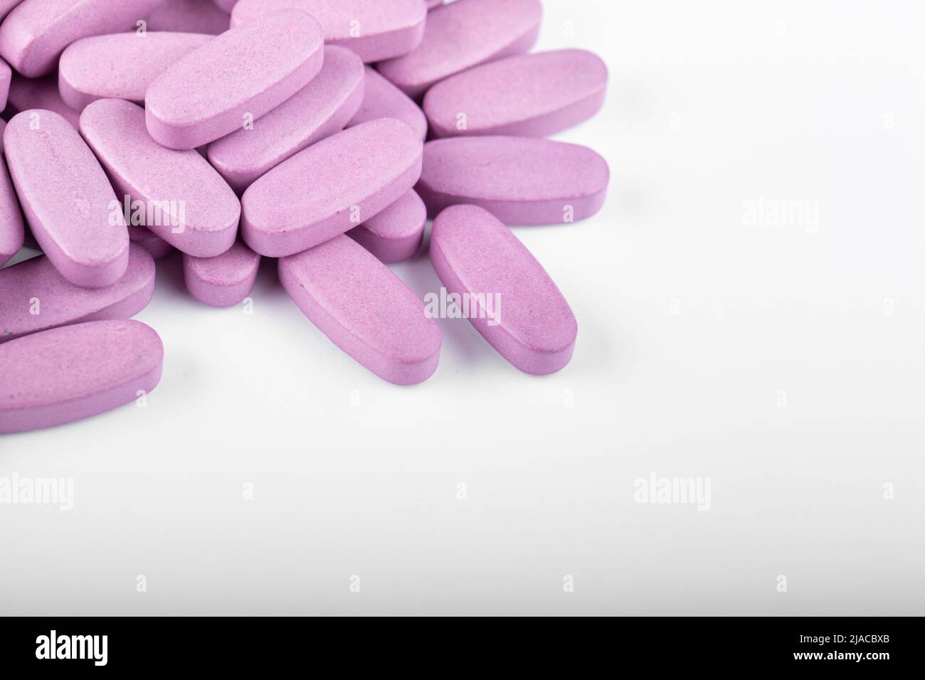 Purple pills on a white background. Global health care concept ...