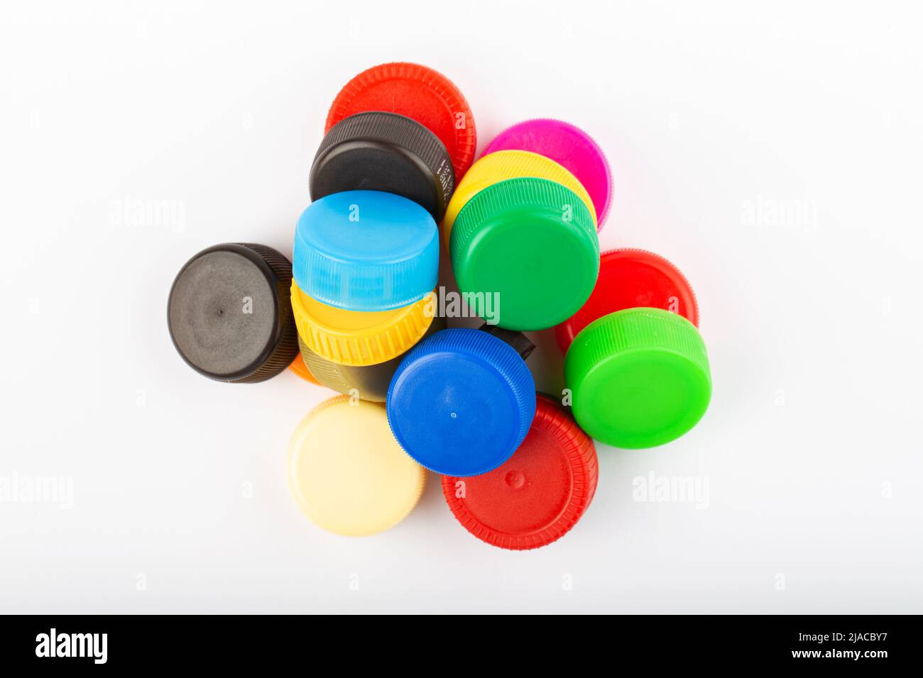 Pile of colored plastic caps on white background. Recycling concept ...