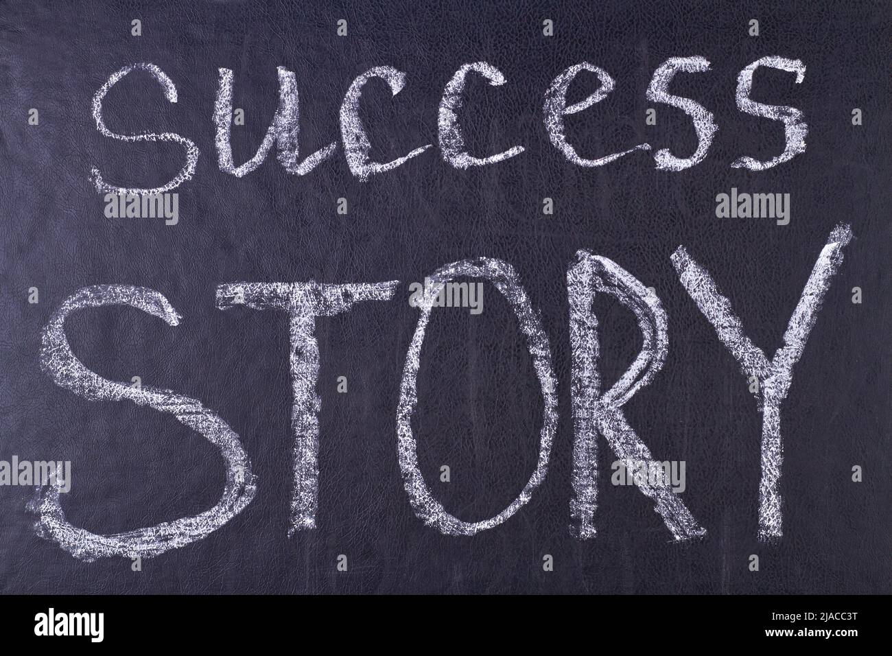 Success story phrase written with chalk on black board. Motivation ...