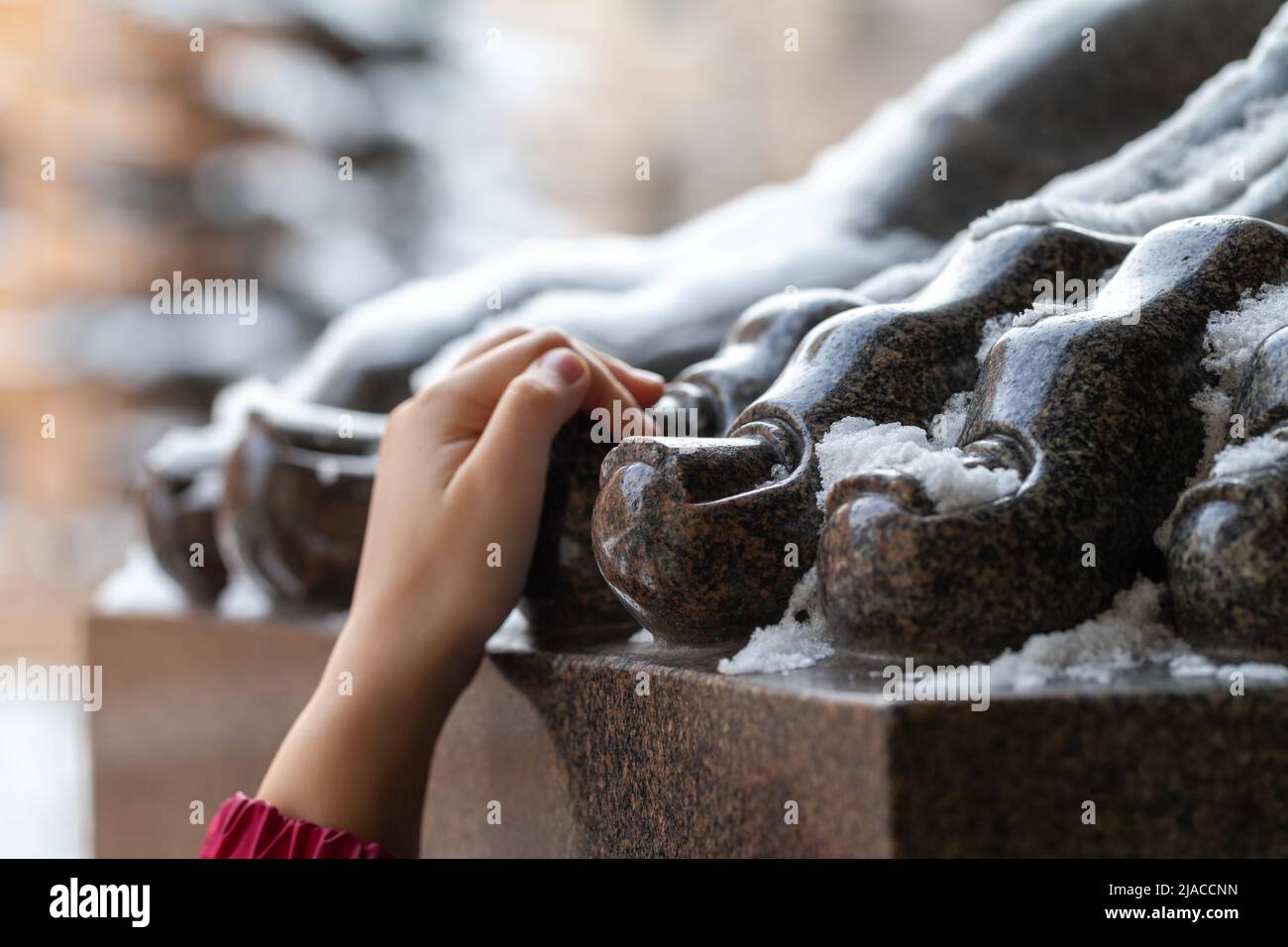 Hand holding a toe of the Atlas statue, tourist omen to make a wish ...