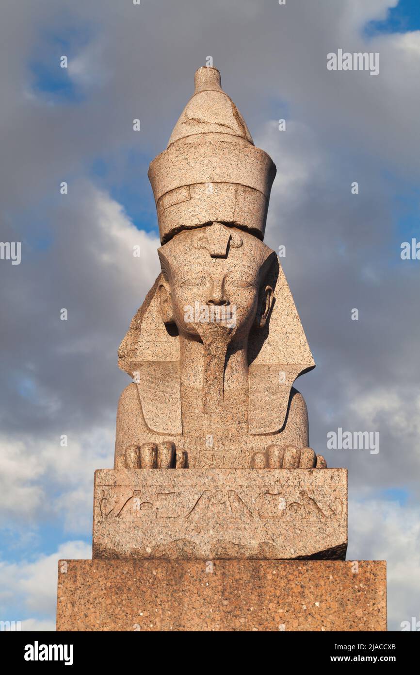 Granite sphinx. Ancient monument is under cloudy sky. Landmark of Neva ...
