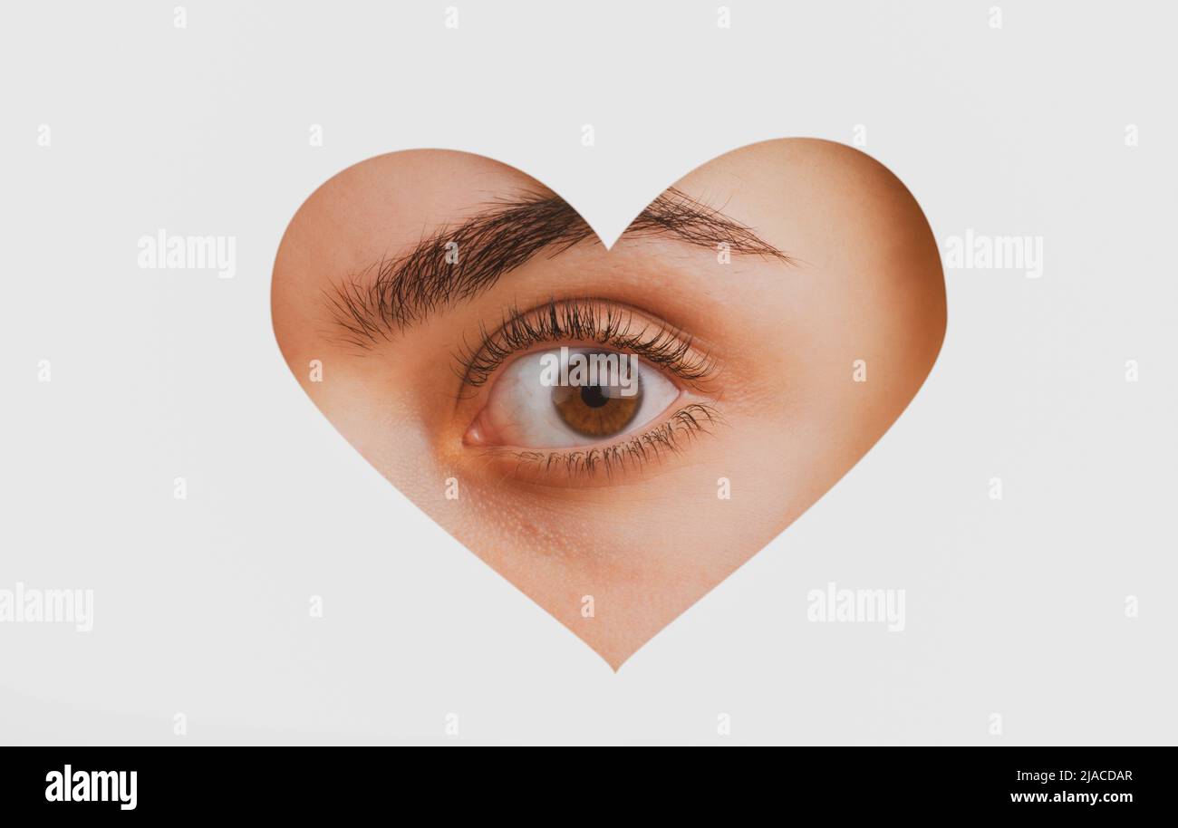 Eye through paper. Ophthalmology. Closeup eyes. Heart shaped hole Stock ...