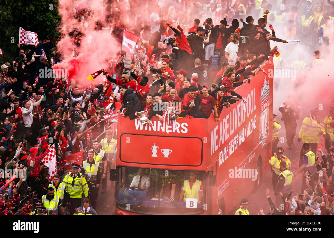 Liverpool fans celebrate as the mens team bus goes past during the ...