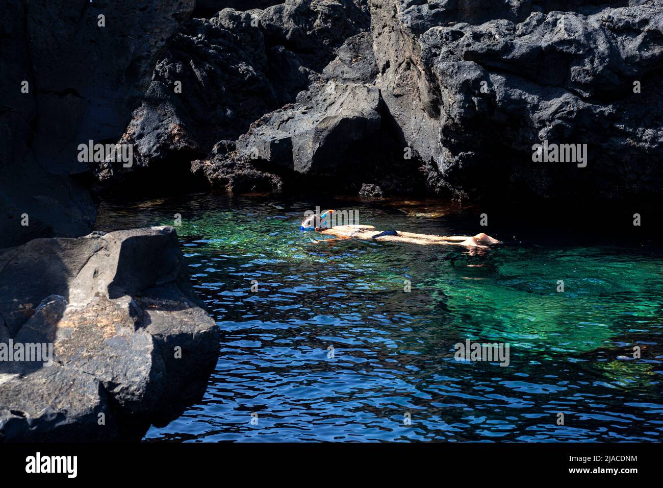 Woman Snorkeling in the blue water of Linosa sea, Linosa Stock Photo ...