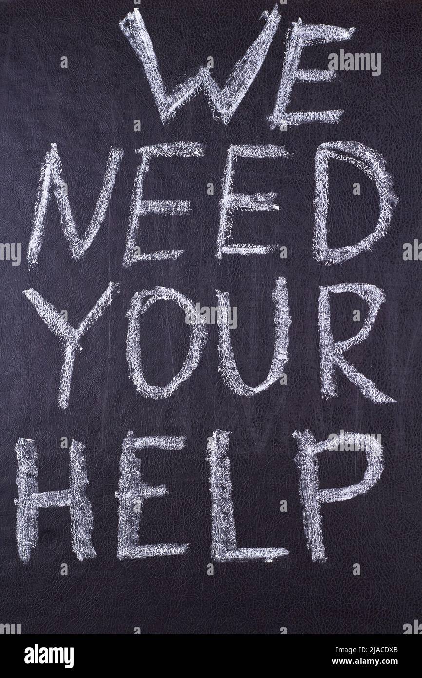 WE NEED YOUR HELP handwritten iscription with a chalk on black ...