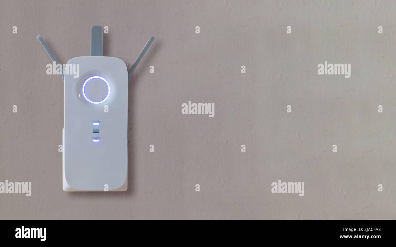 Wifi Extender Wireless repeater home device at power outlet on grey ...