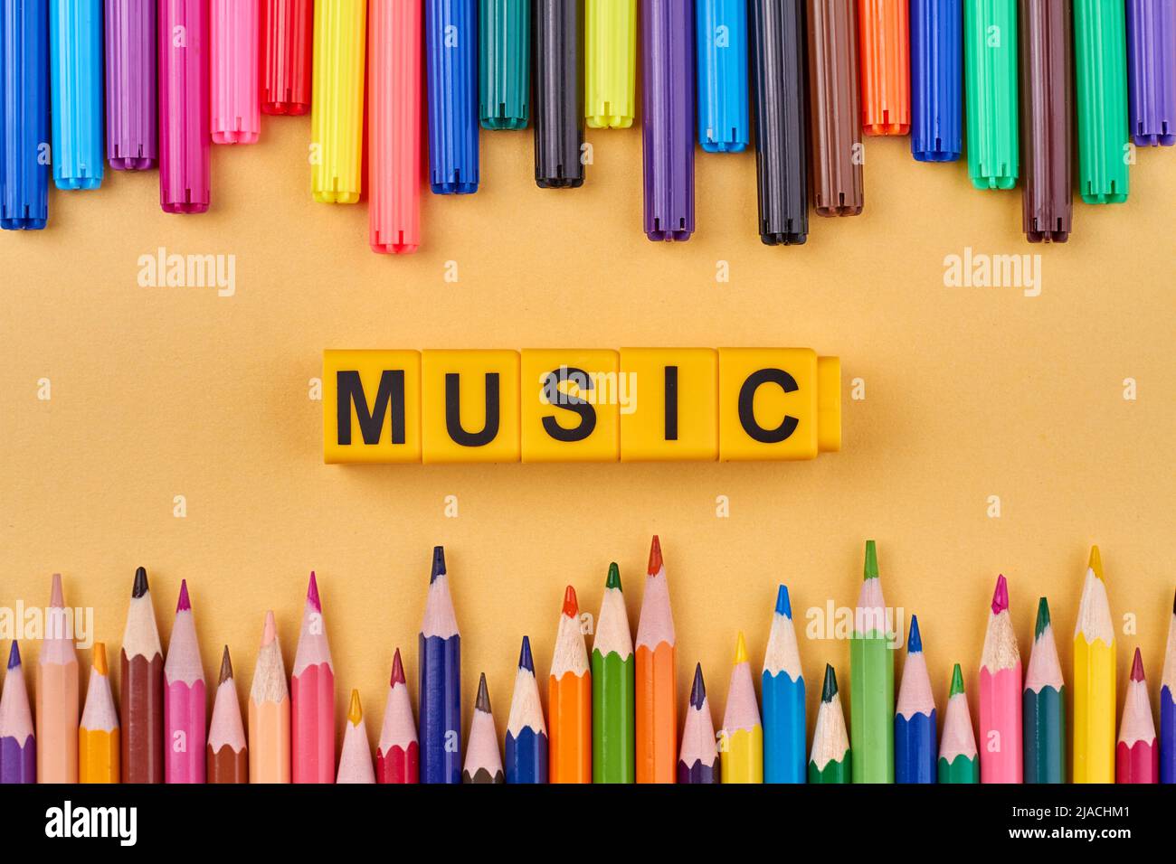The word MUSIC written on yellow cubes against color background. Flat ...