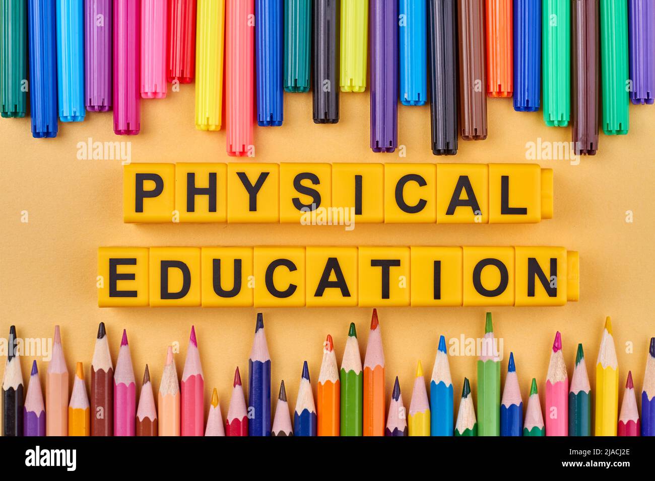 The inscription physical education written on yellow cubes against ...