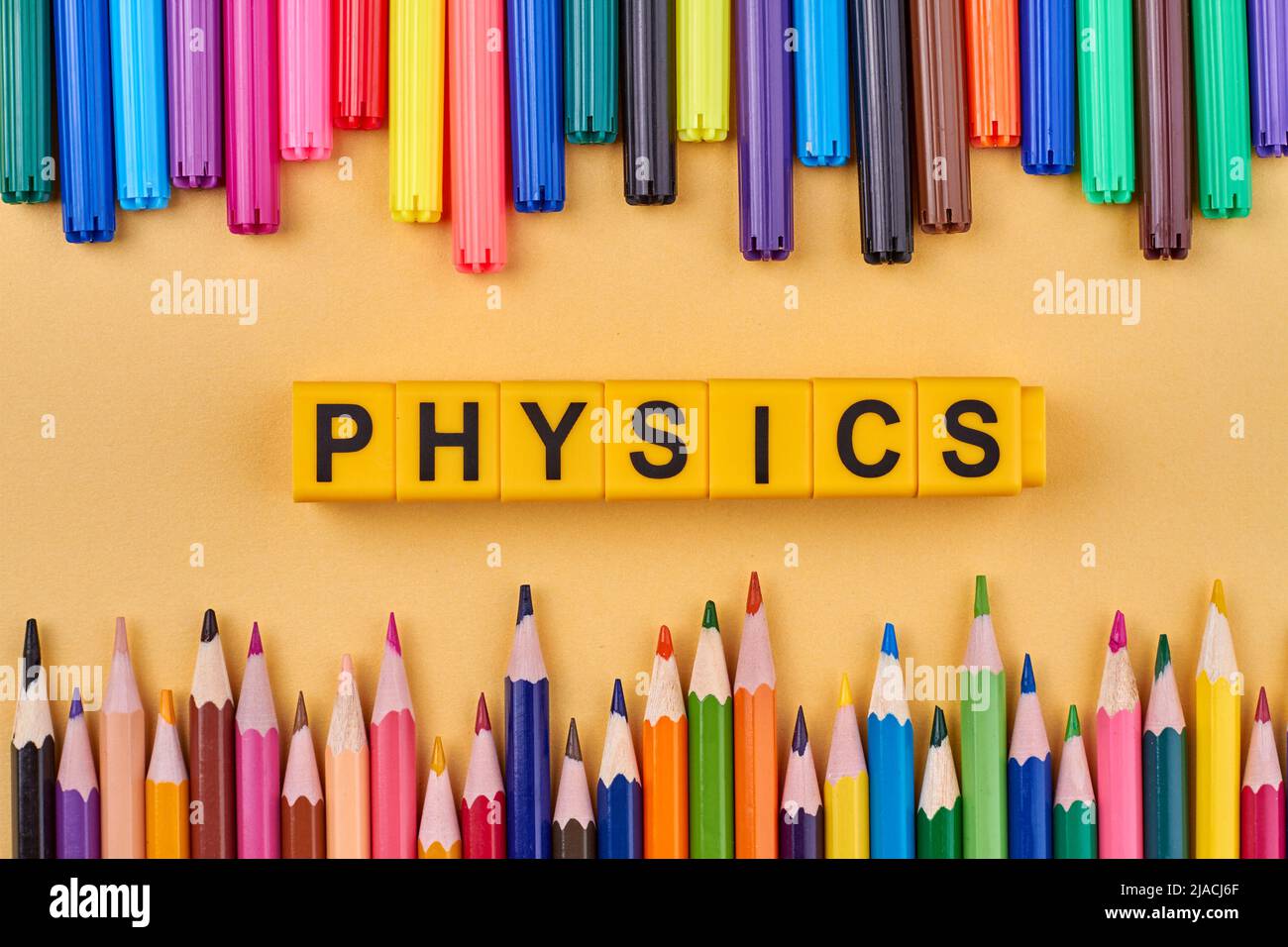 Word physics written on yellow cubes in frame from colorful school ...