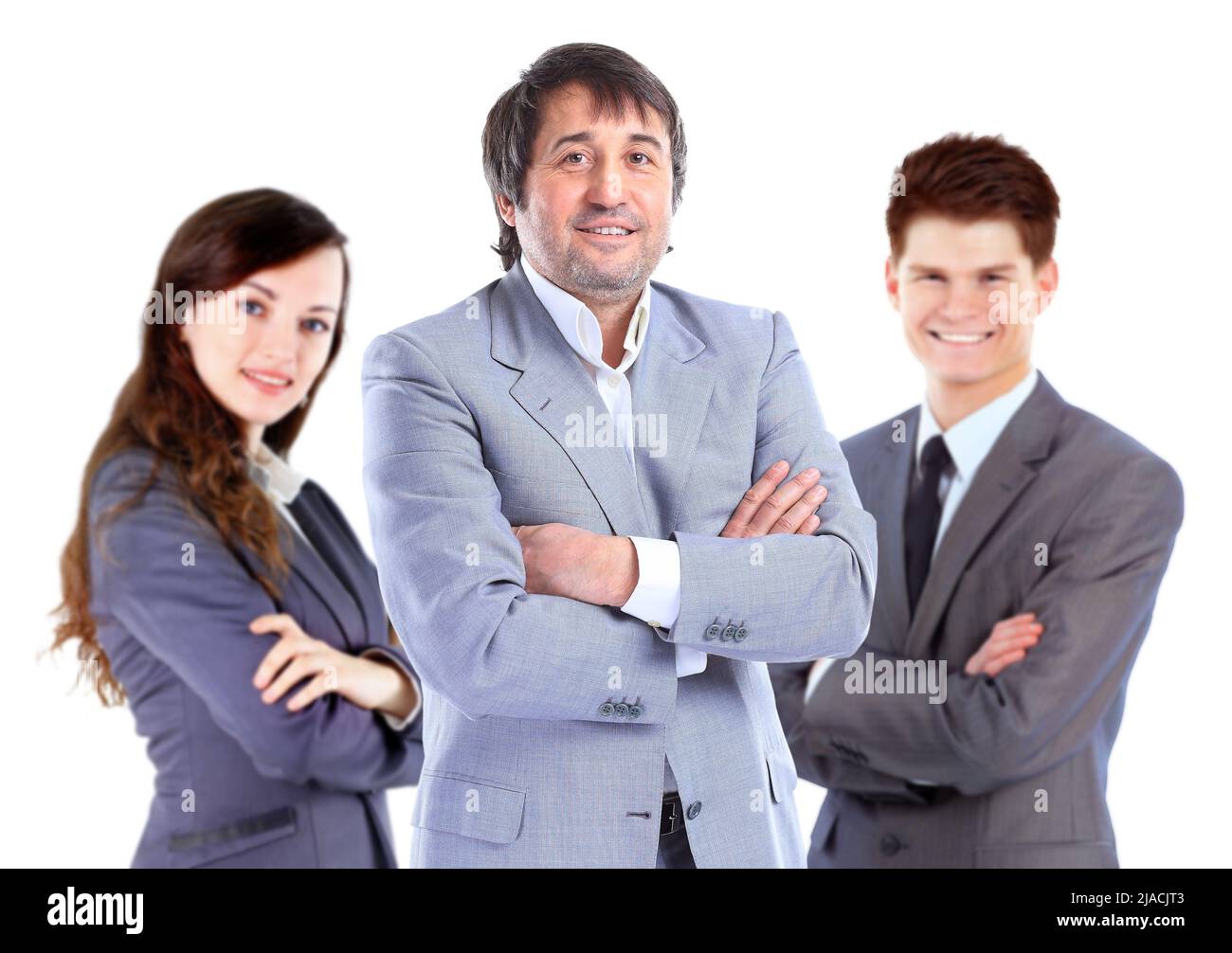 Smiling business team standing upright with their hands on their hips ...