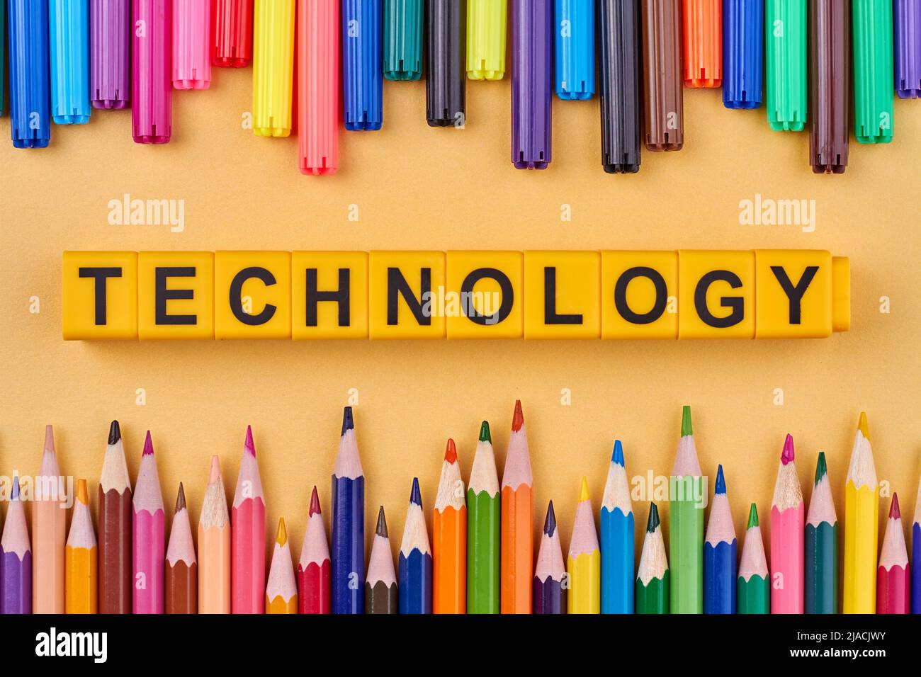 The word technology written on yellow cubes. Flat lay with colorful ...