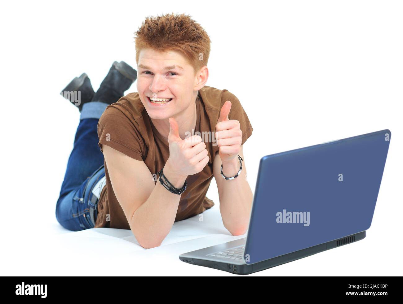 Successful happy man lying down o n floor using laptop Stock Photo - Alamy