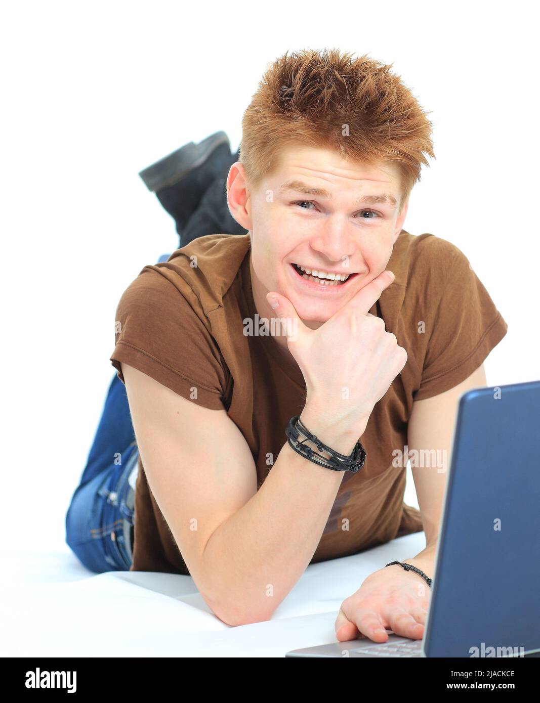 Successful happy man lying down o n floor using laptop Stock Photo - Alamy