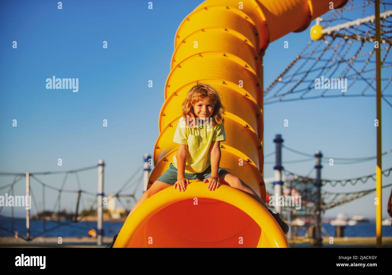 Funny cute kid playing in tunnel slide on playground Stock Photo - Alamy