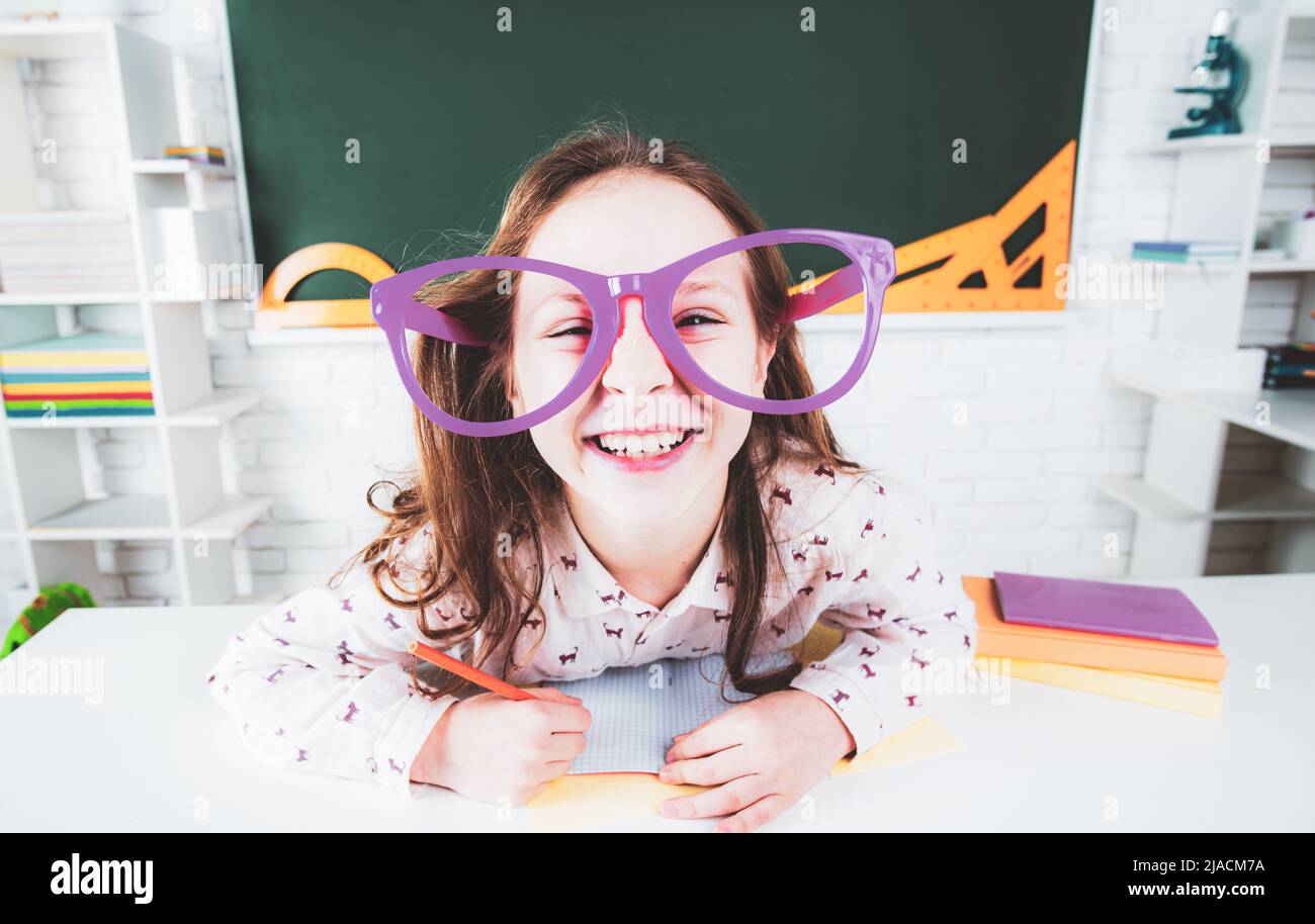 Funny pupil in glasses in classroom. Little ready to study. Back to ...