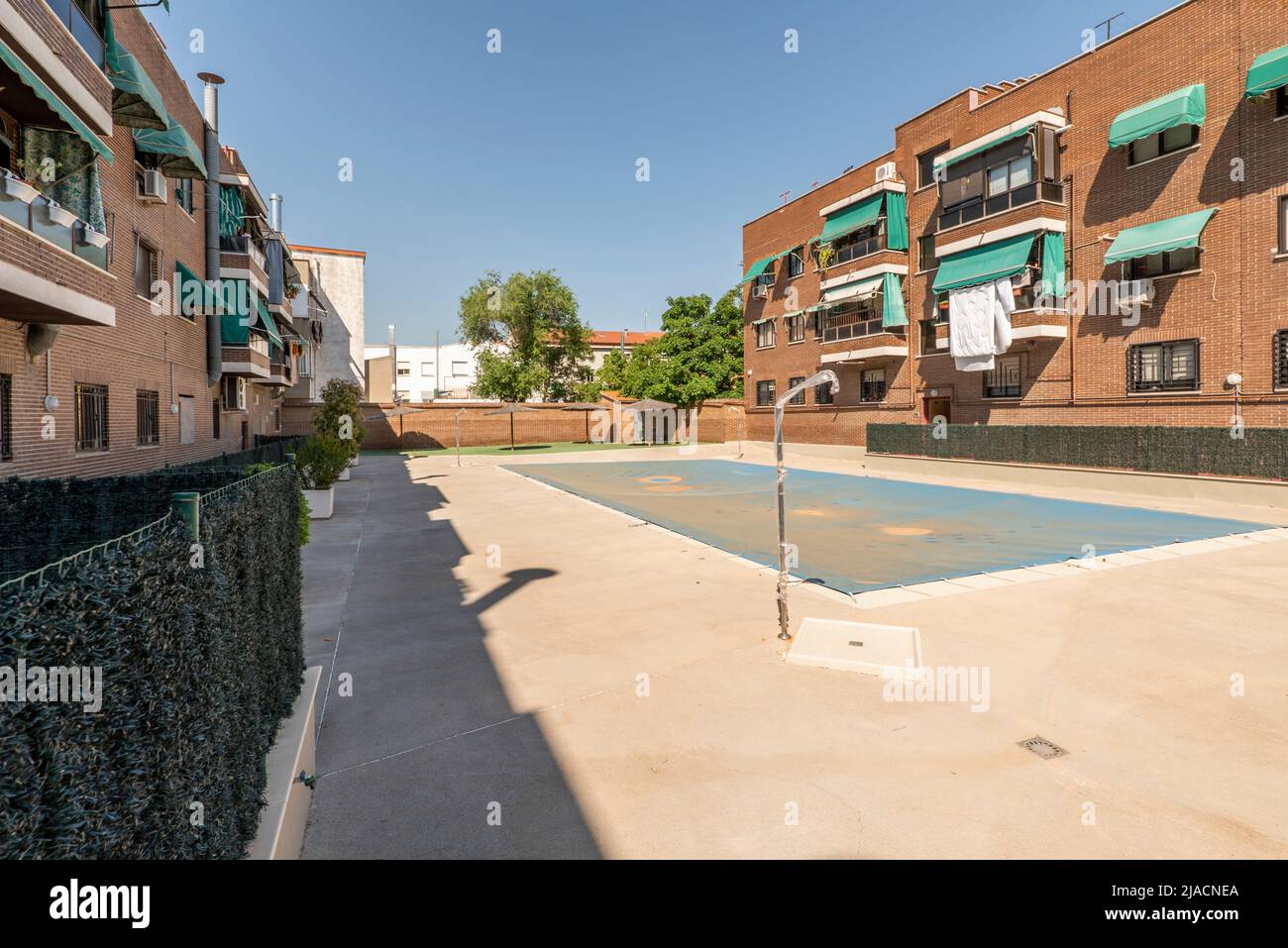 Community covered terrace with blue canvas in a residential housing ...