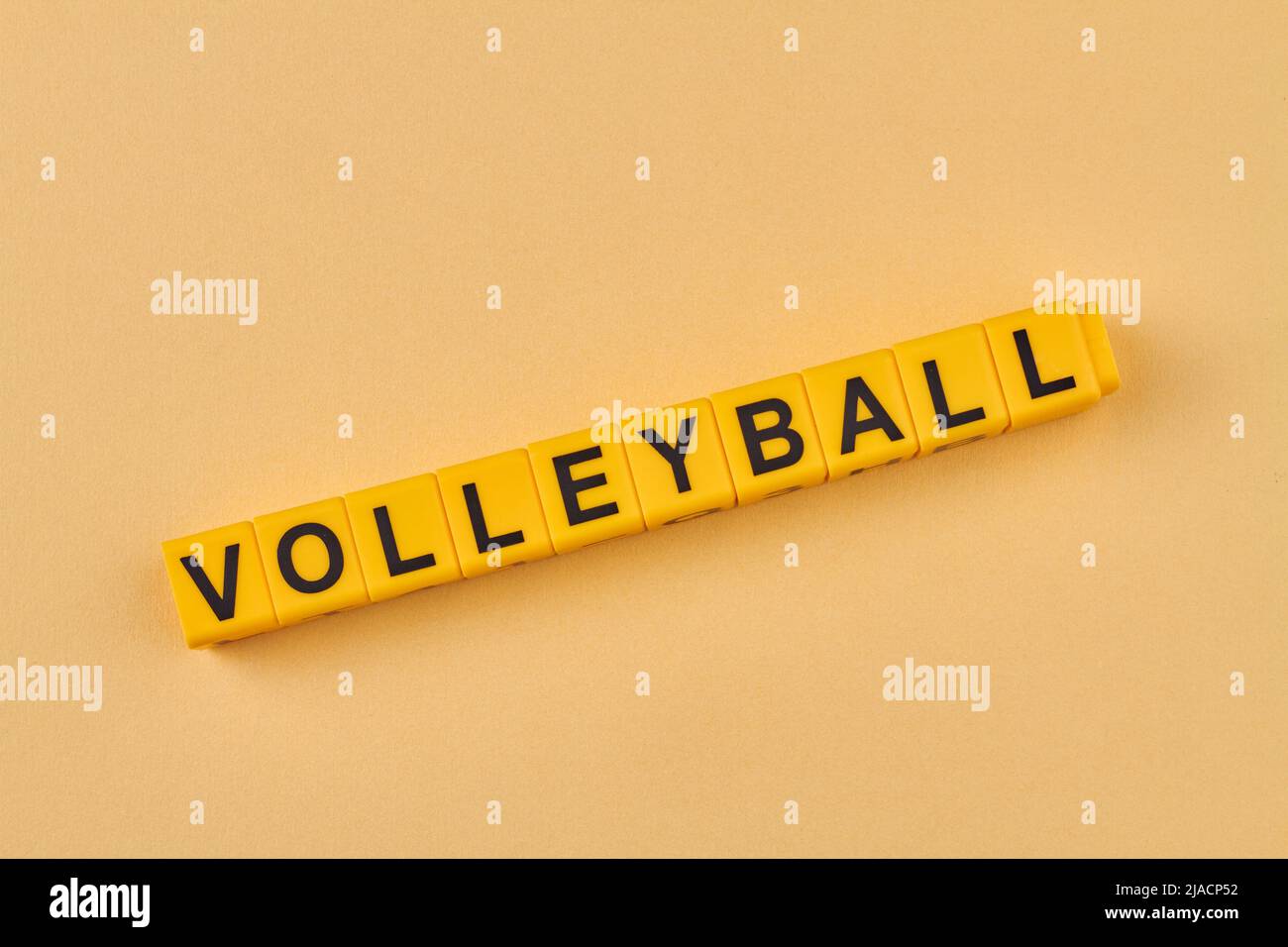 The word valleyball written on yellow cubes against color background ...