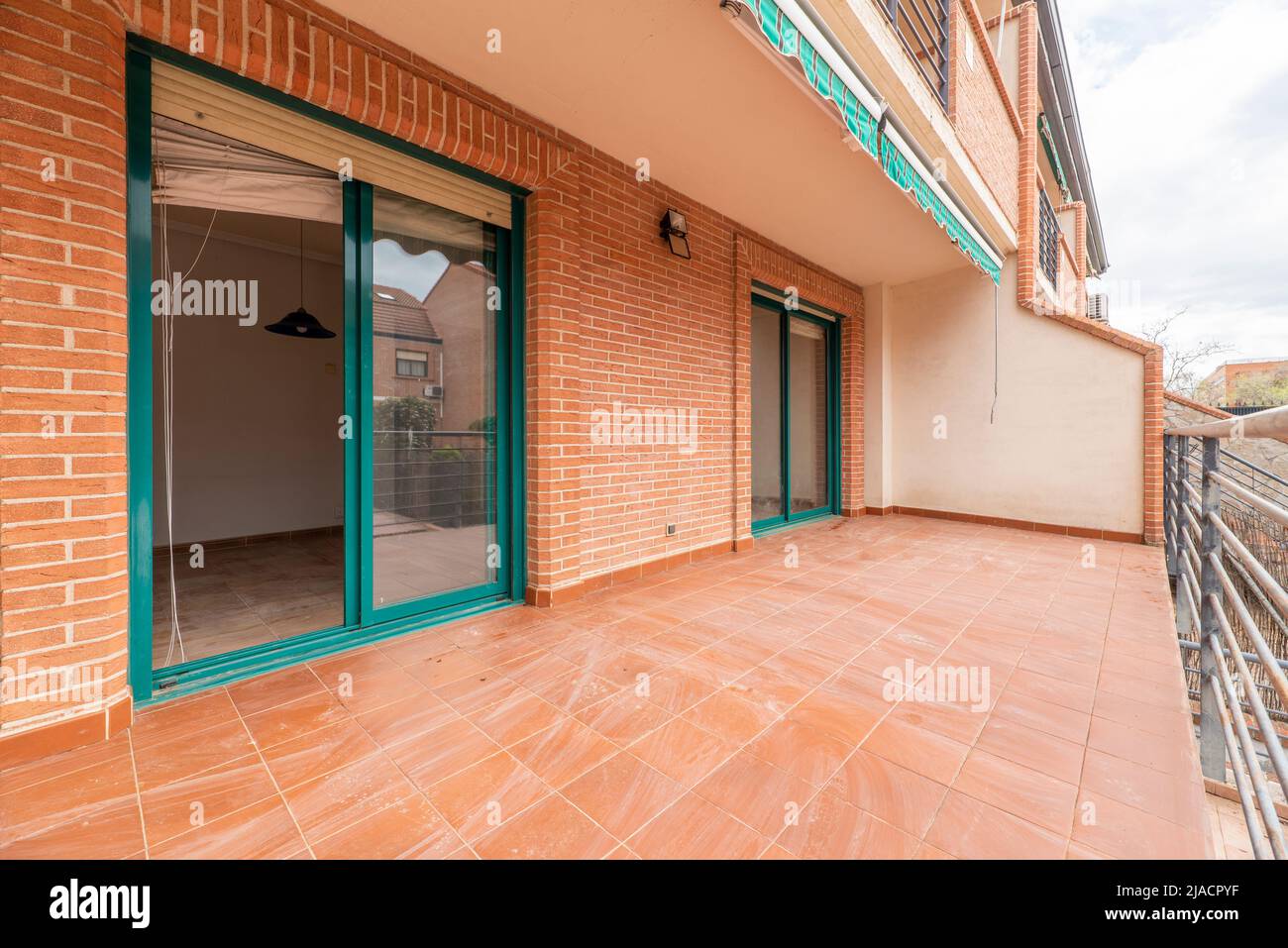 Terrace of a single-family home with a porch and green aluminum and ...