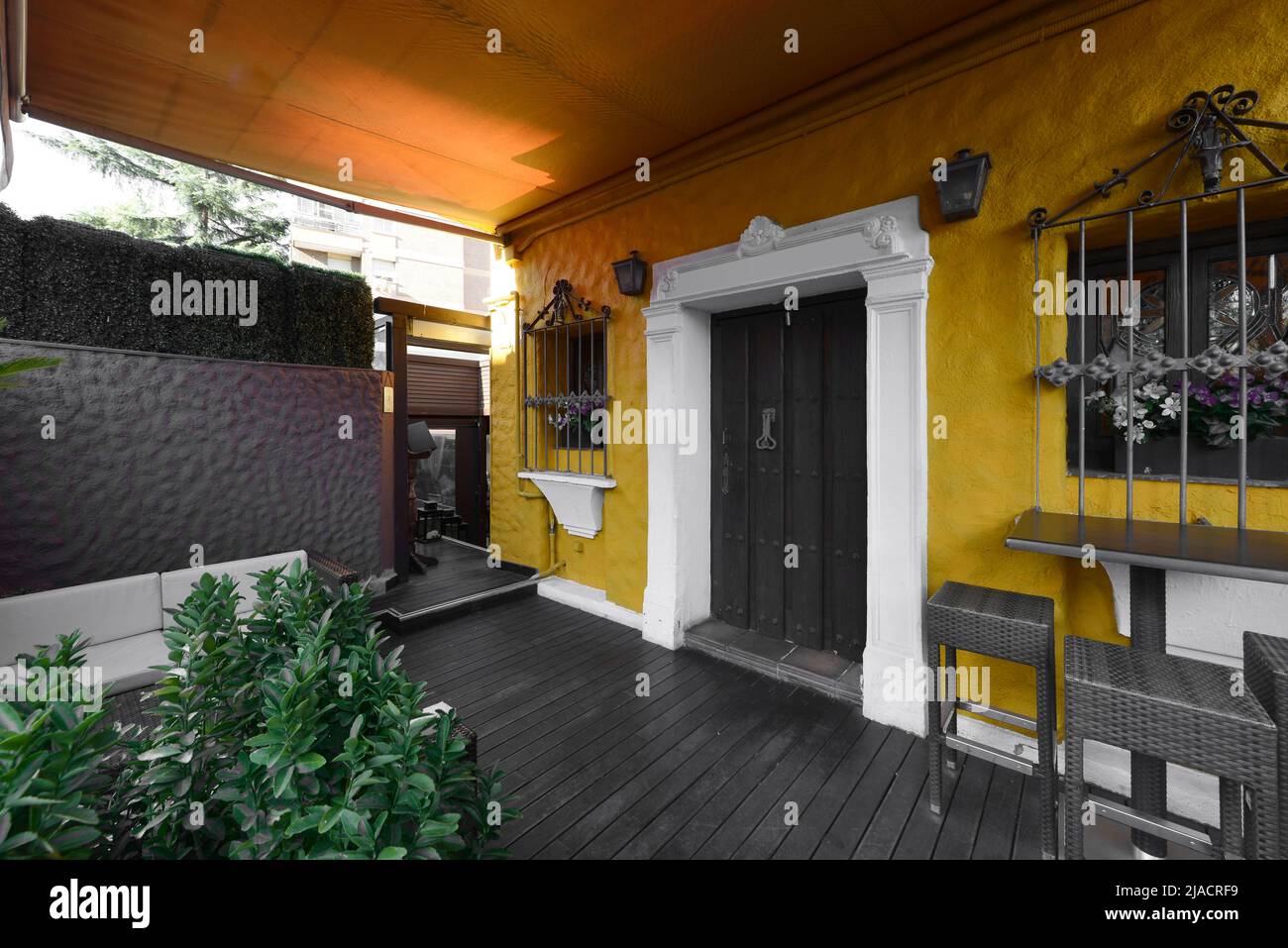Terrace and hall with dark wood floors, wooden panel door and green ...
