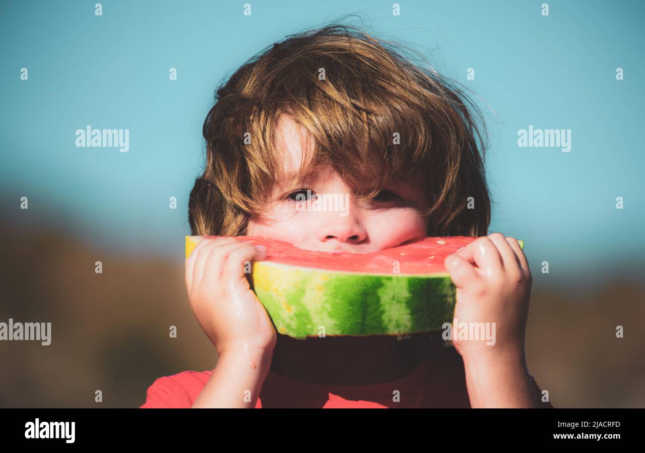 Happy boy eating watermelon. Cute boy eating healthy food melon in ...